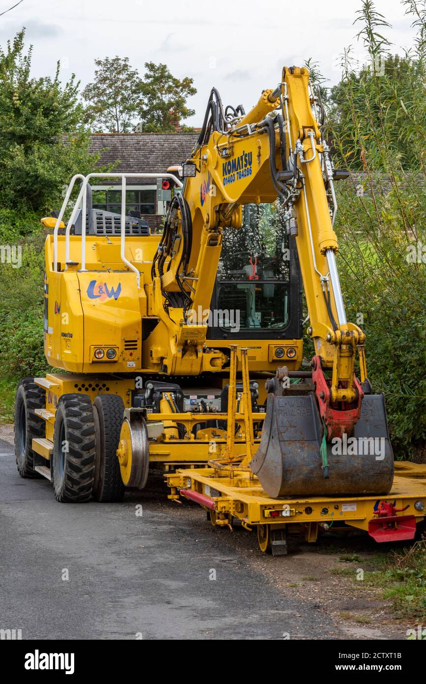 a road rail machine parked at the roadside close to the railway in ...