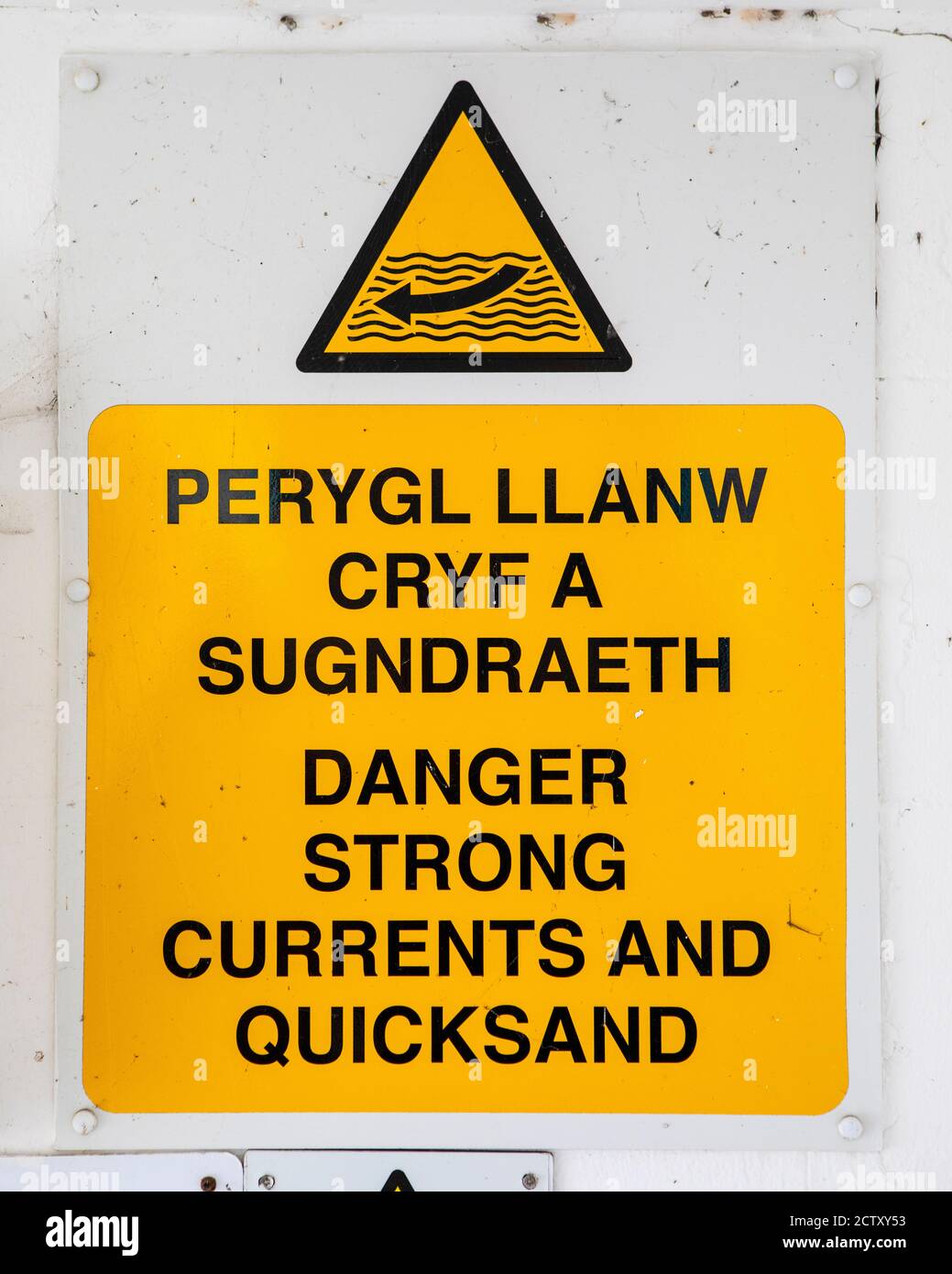 Close-up of a Danger sign in Portmeirion, Wales - in both the Welsh and ...