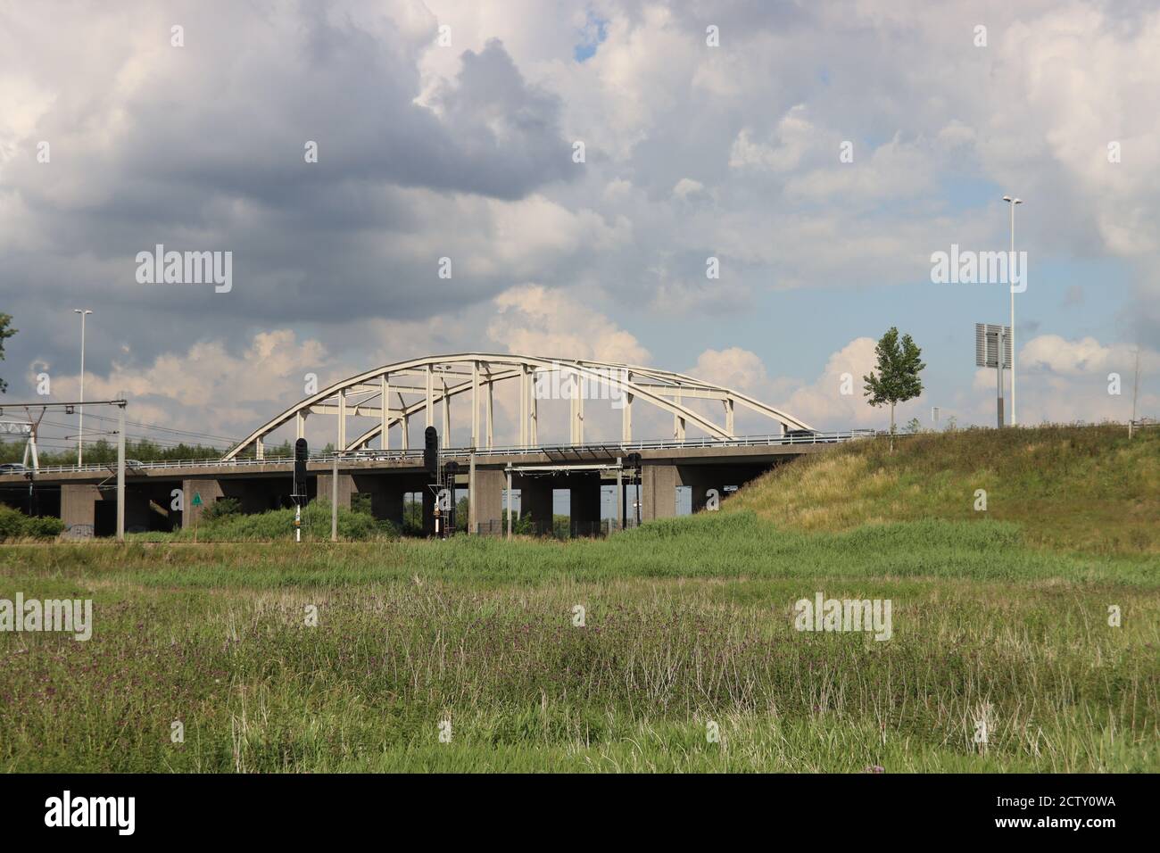 White steel bridge over railroad track at motorway A20 at Moordrecht ...