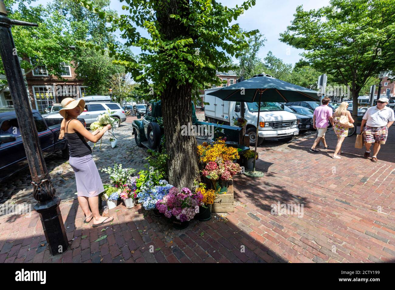 Street flower vendor in the cobblestone Main Street in historic ...