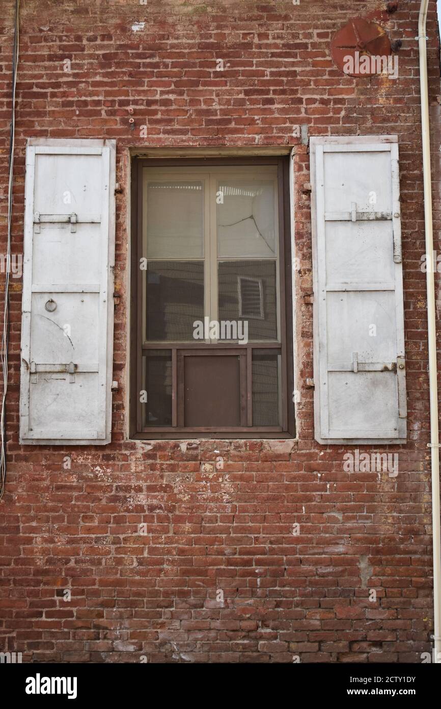 Vertical shot of an old window on a brick building Stock Photo - Alamy