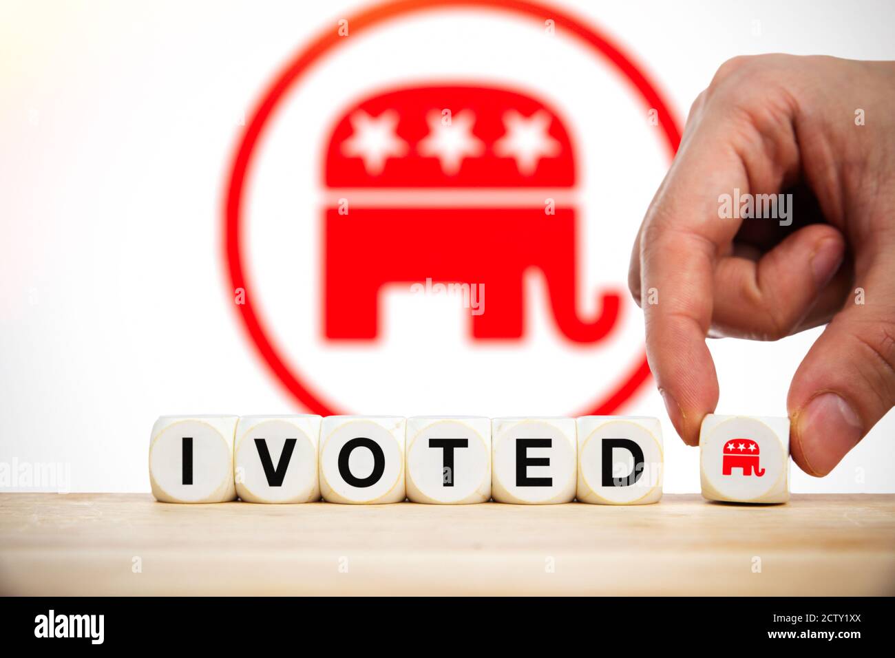 Hand bringing dice sprlling out I voted republican with elephant party ...