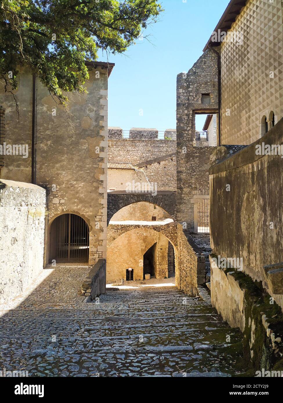 the stone walls and the tower of the famous Caetani Castle of Sermoneta ...