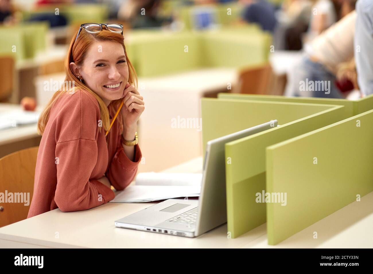 A female student posing for a photo at a lecture in a classroom Stock ...
