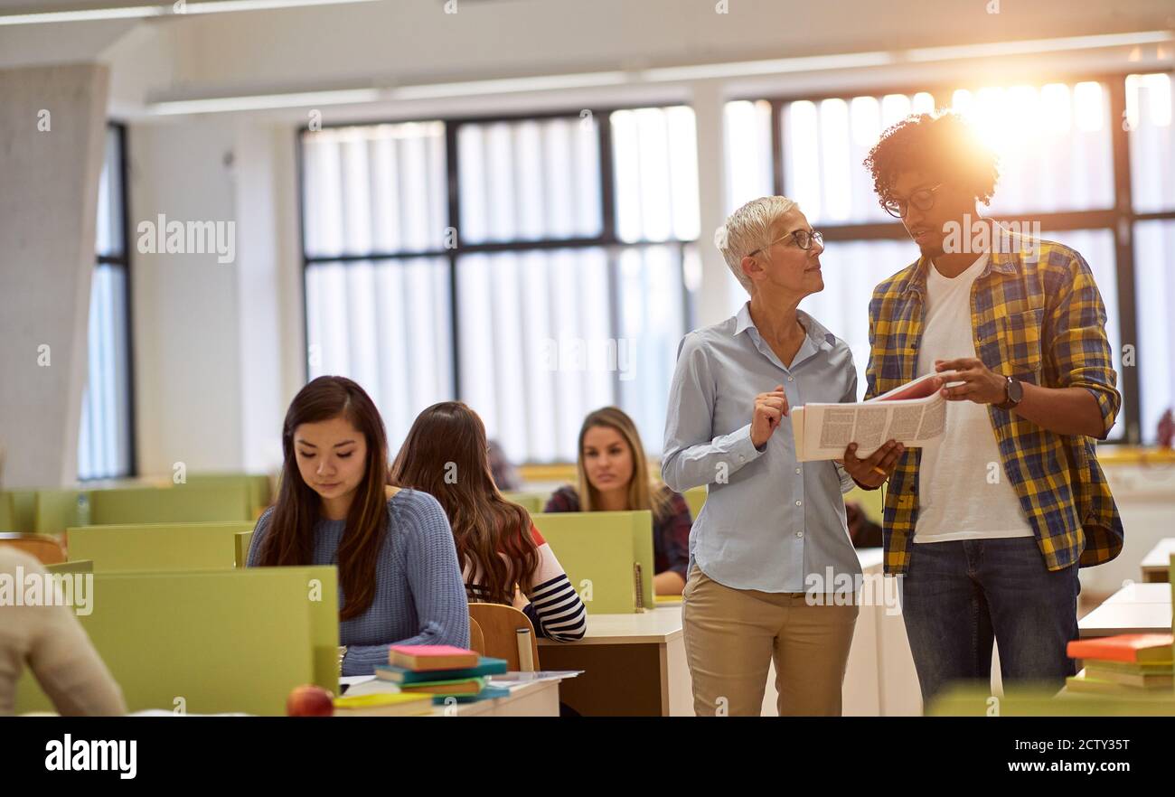 College Students Asking Questions In The Classroom