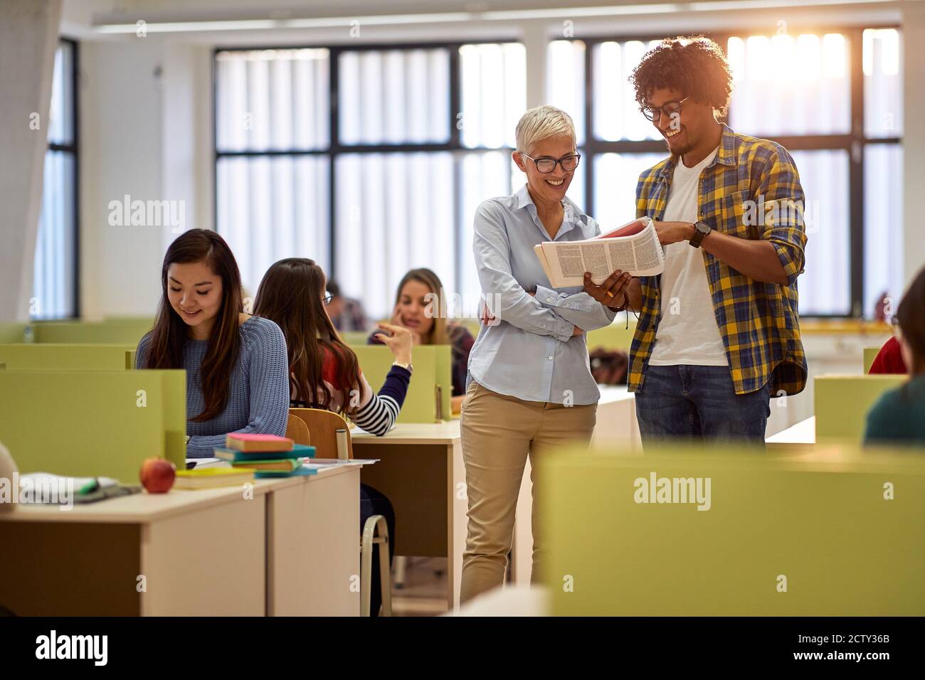 Male student and female professor enjoying discussion about the lesson ...