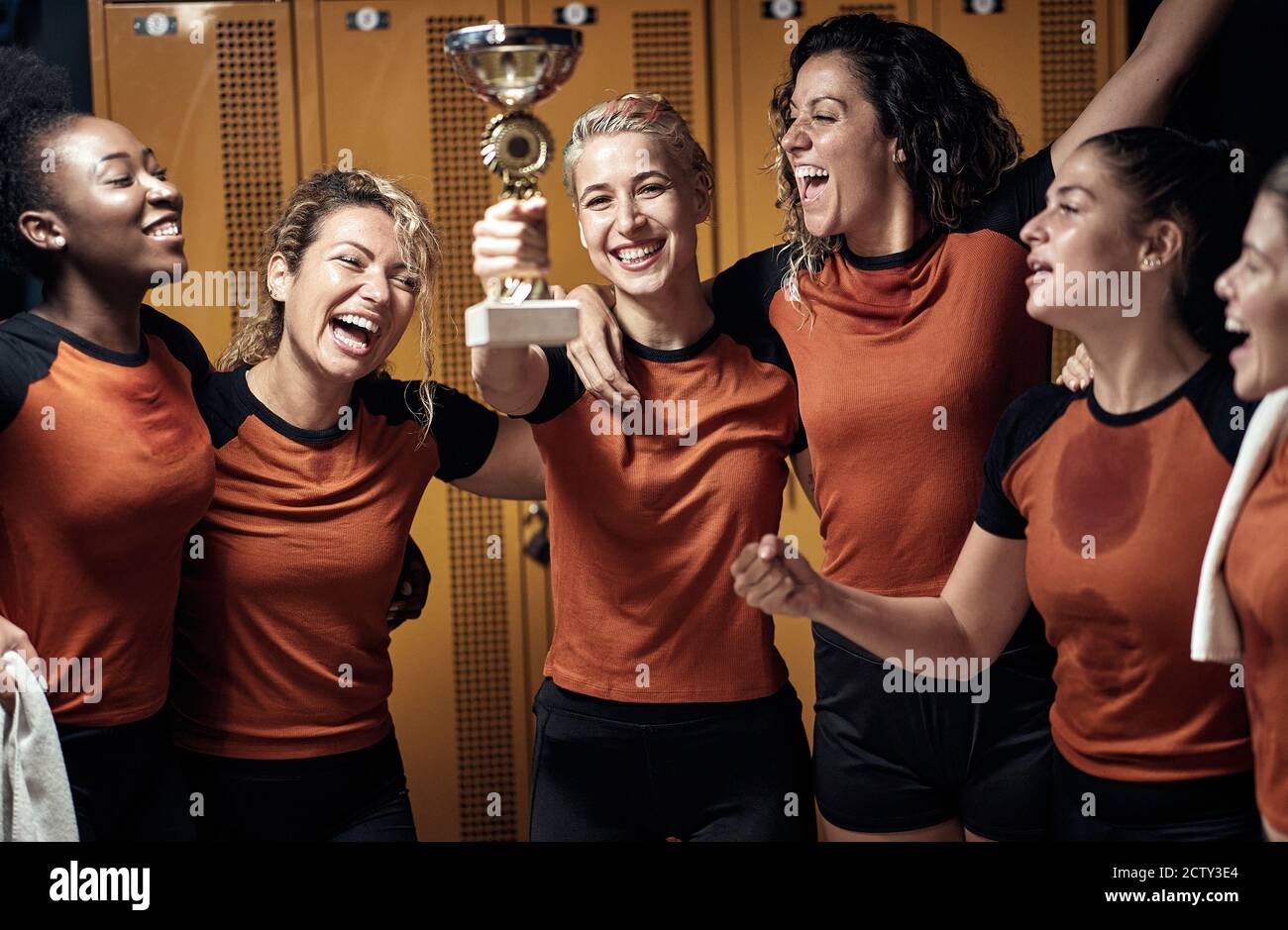 Female team in a locker room feeling strong after the win Stock Photo ...