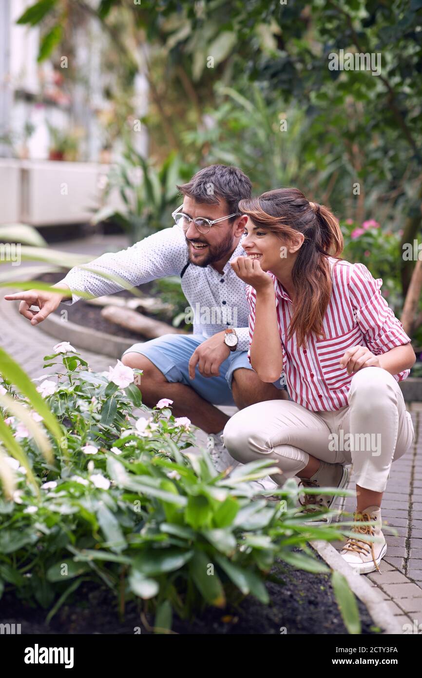 Young couple observing beautiful plants in a botanical garden Stock ...
