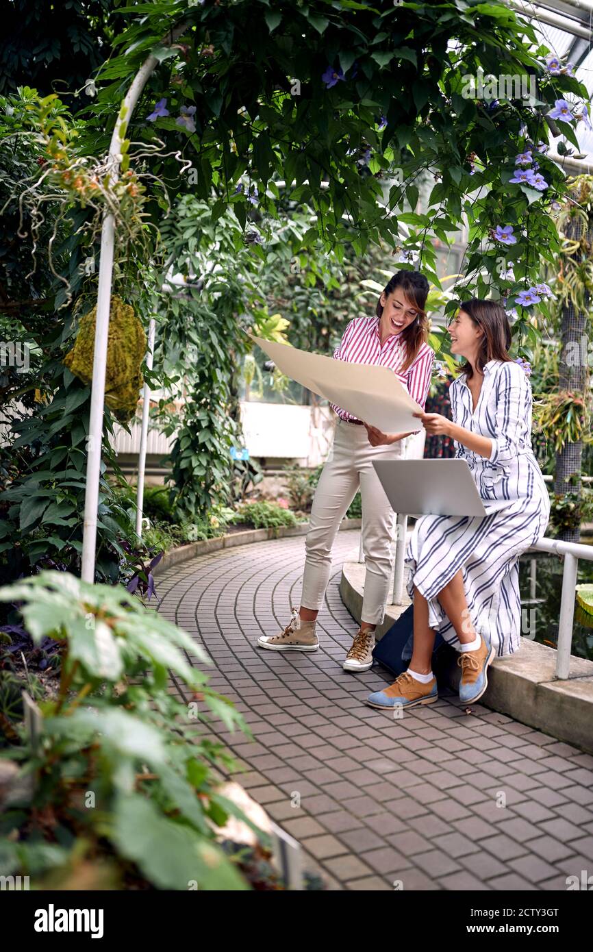 Young cheerful female biology students enjoying the work on the ...