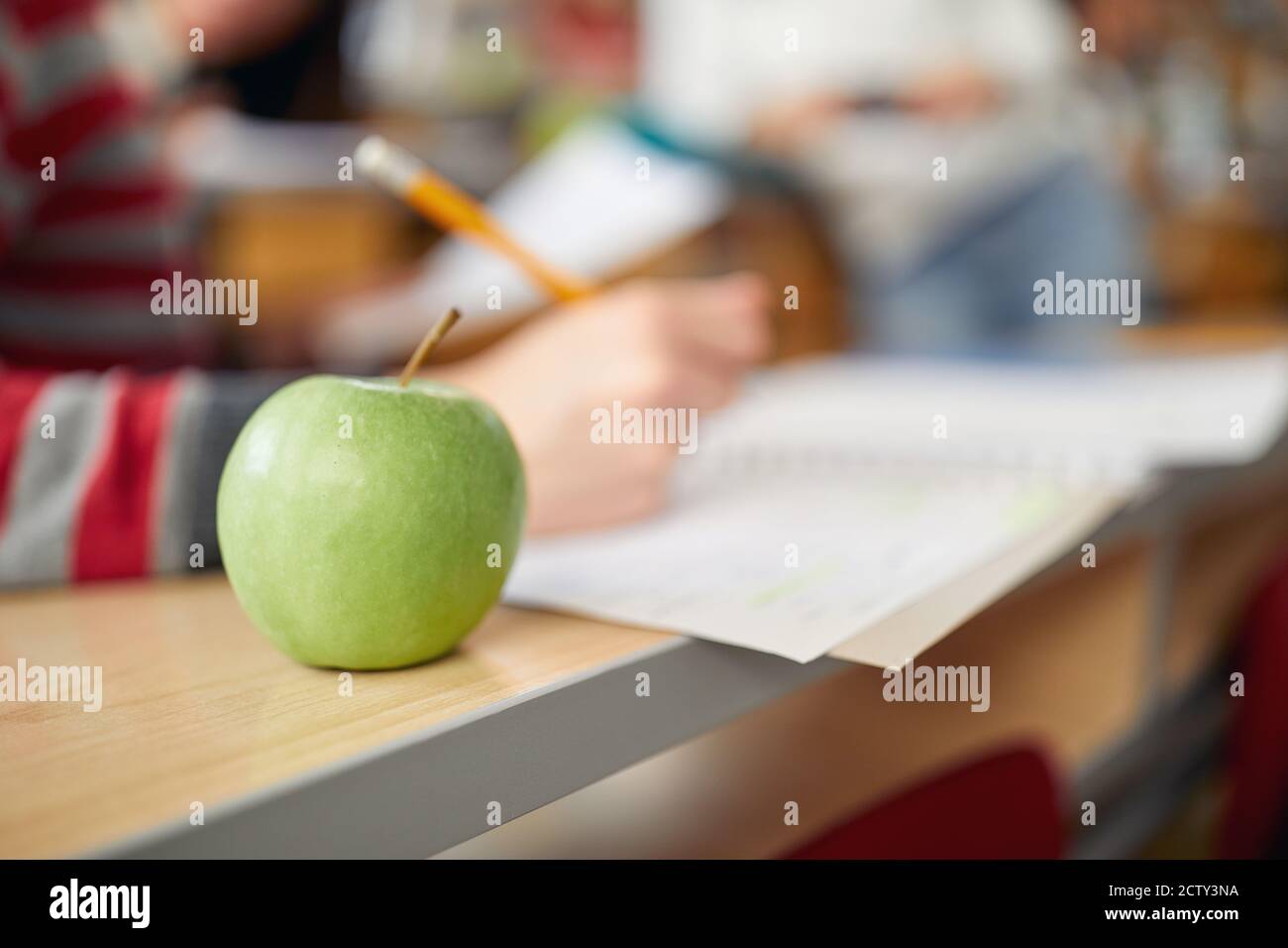 An apple as student's snack for the break in the university classroom ...