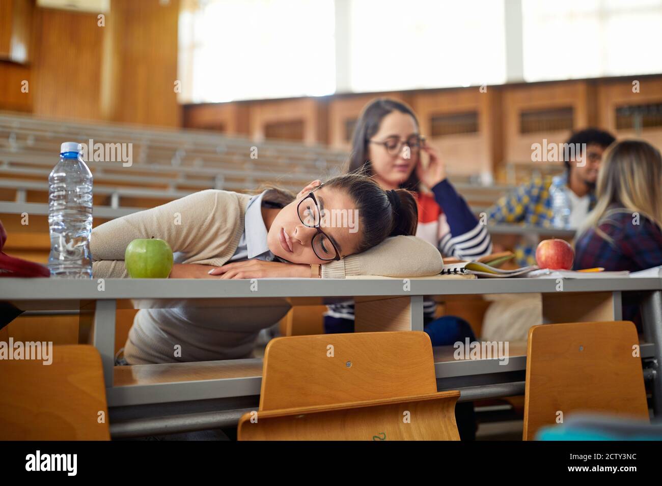 Tired female student taking a nap at the lecture break in the ...