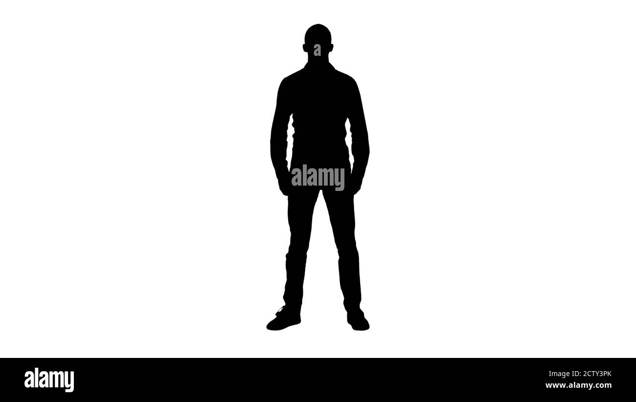 Silhouette Strict man standing and looking into camera Stock Photo - Alamy