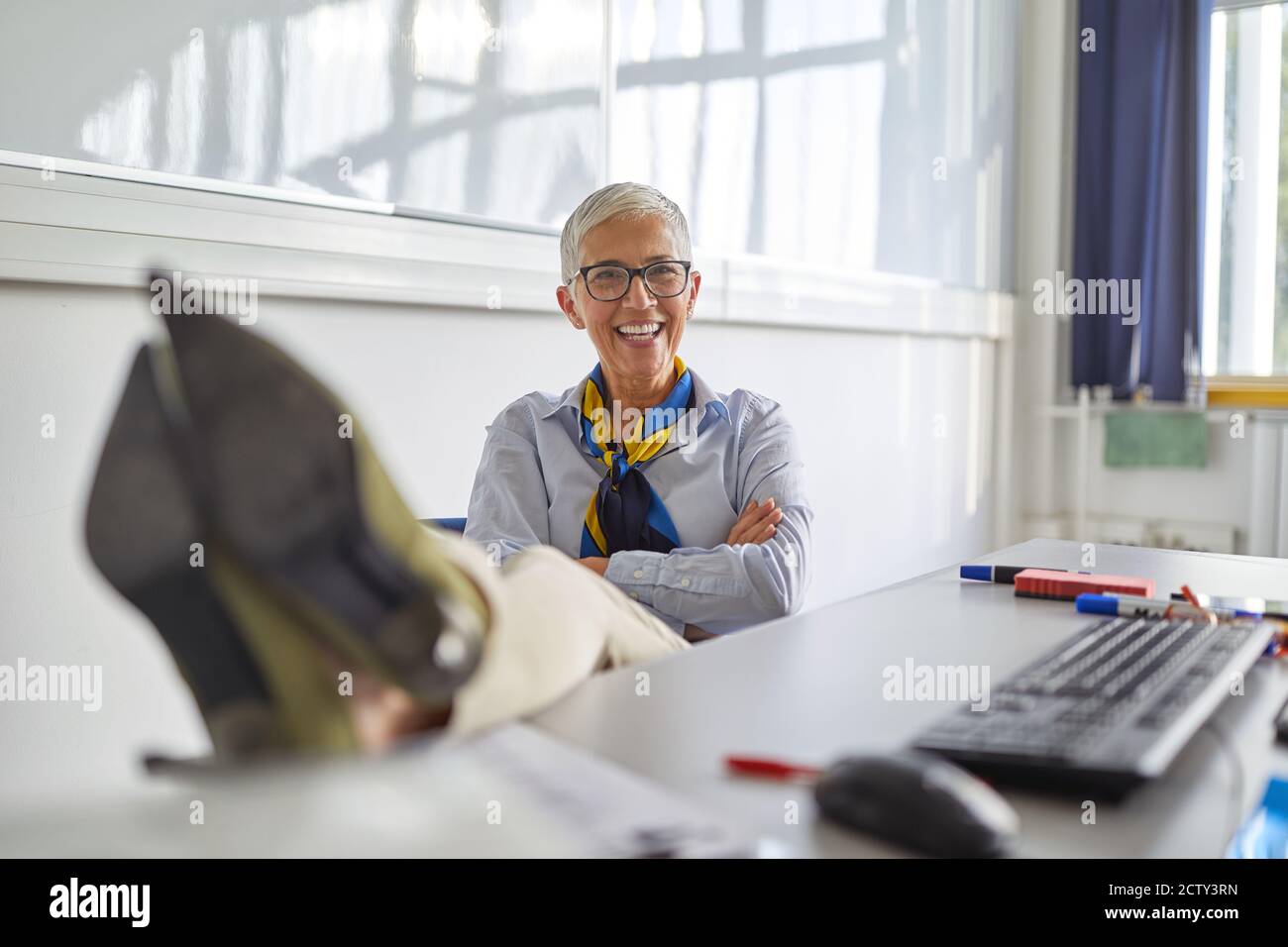 Female professor relaxing in the university classroom after the lecture ...