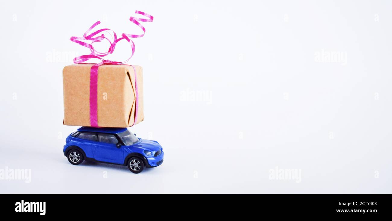 Blue retro toy car delivering gift box for Valentine's day on white ...