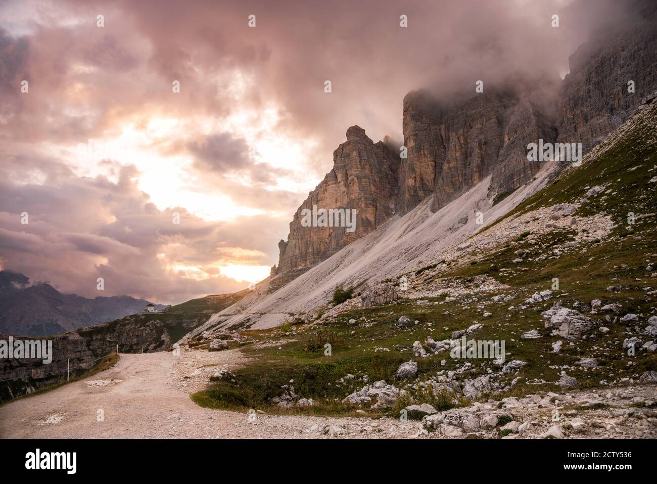 Majestic sunset over a deserted mountain path running at the foot of ...