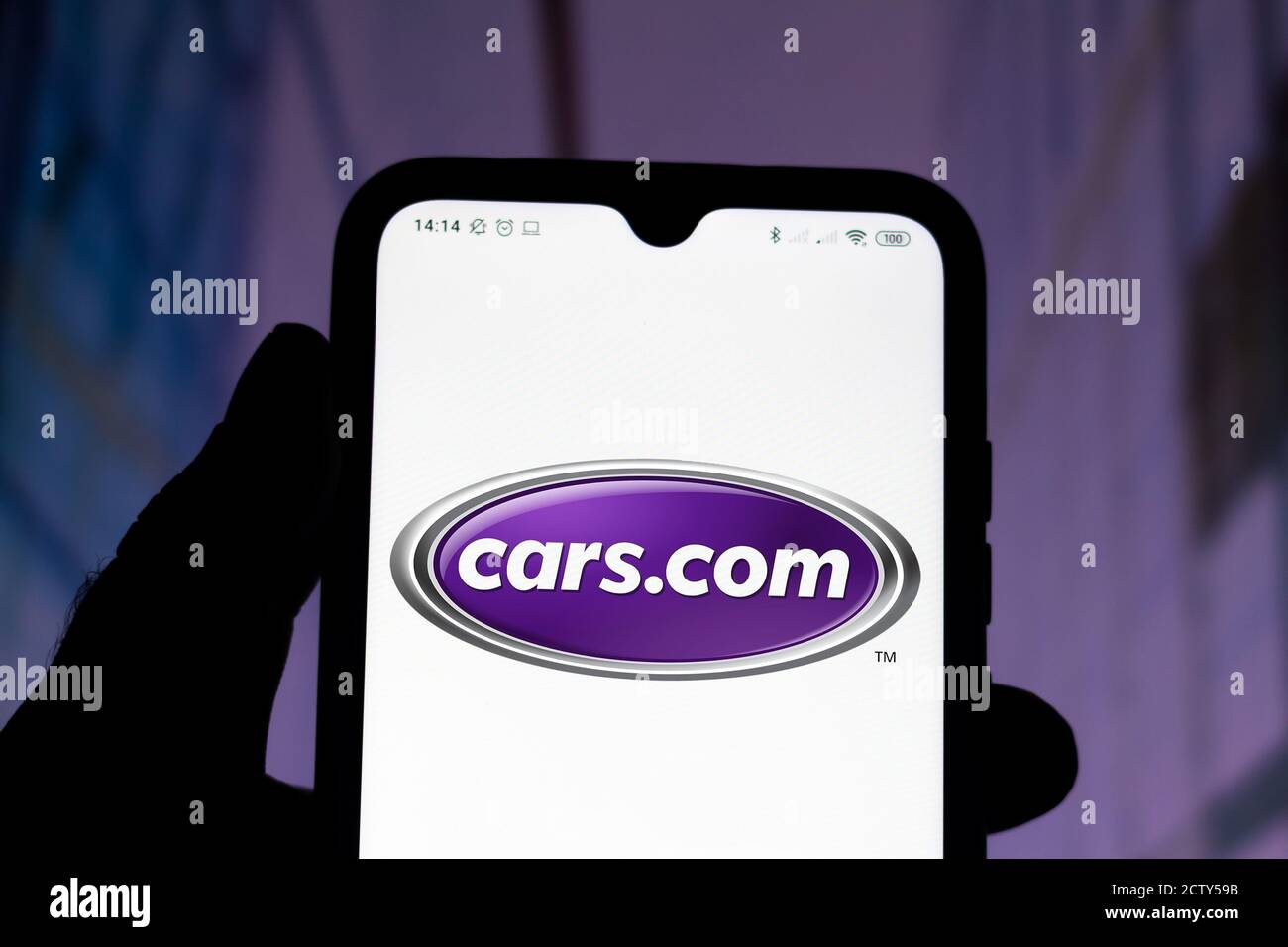In this photo illustration the Cars.com logo seen displayed on a ...