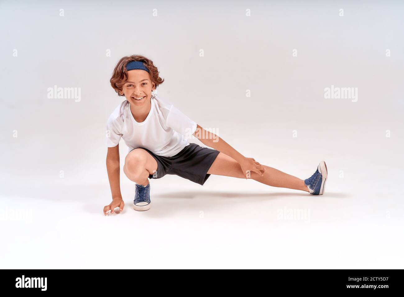 Improving flexibility. Full length of caucasian teenage boy in ...