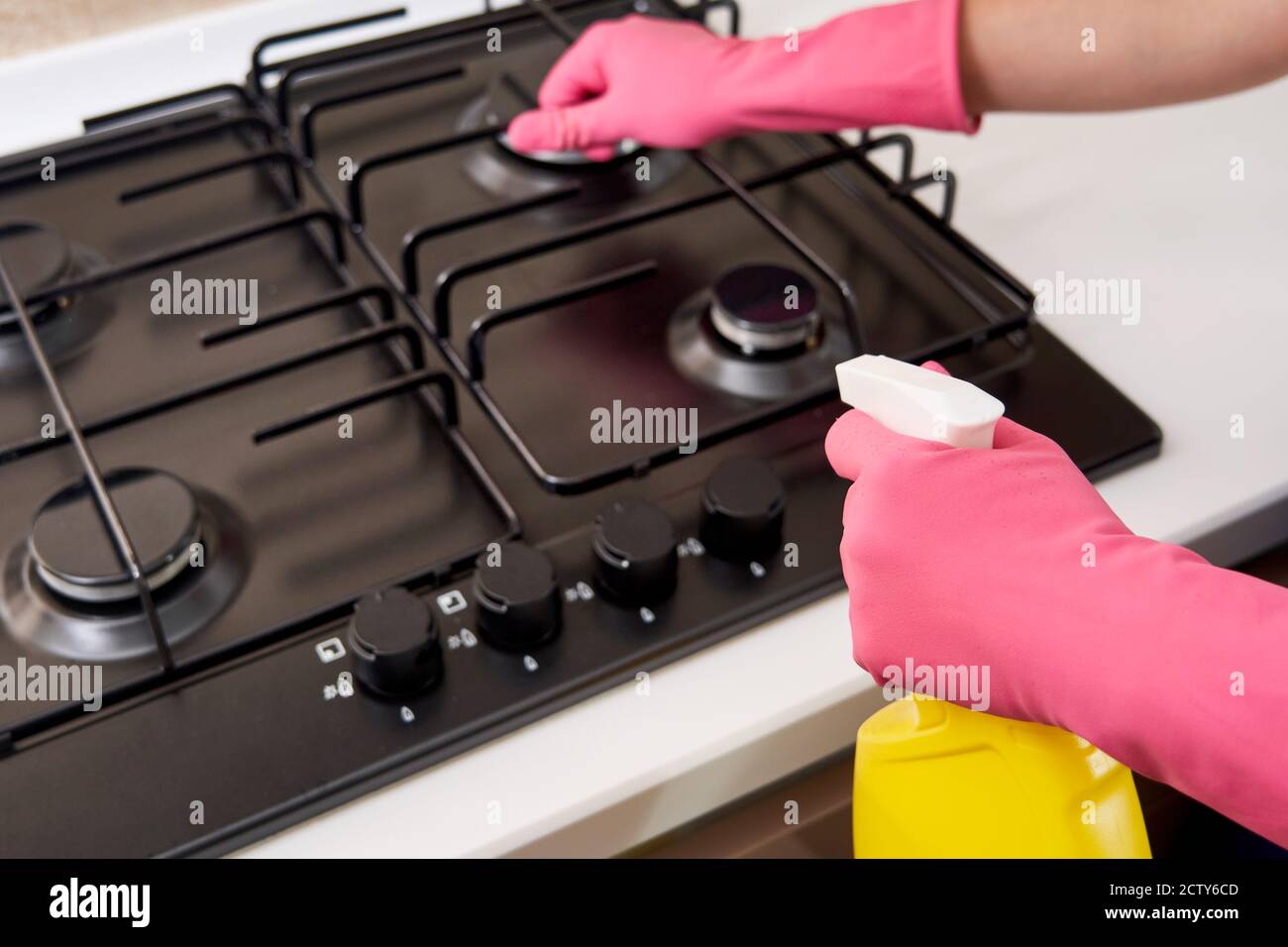Cleaning a gas stove with kitchen utensils, household concepts, or ...