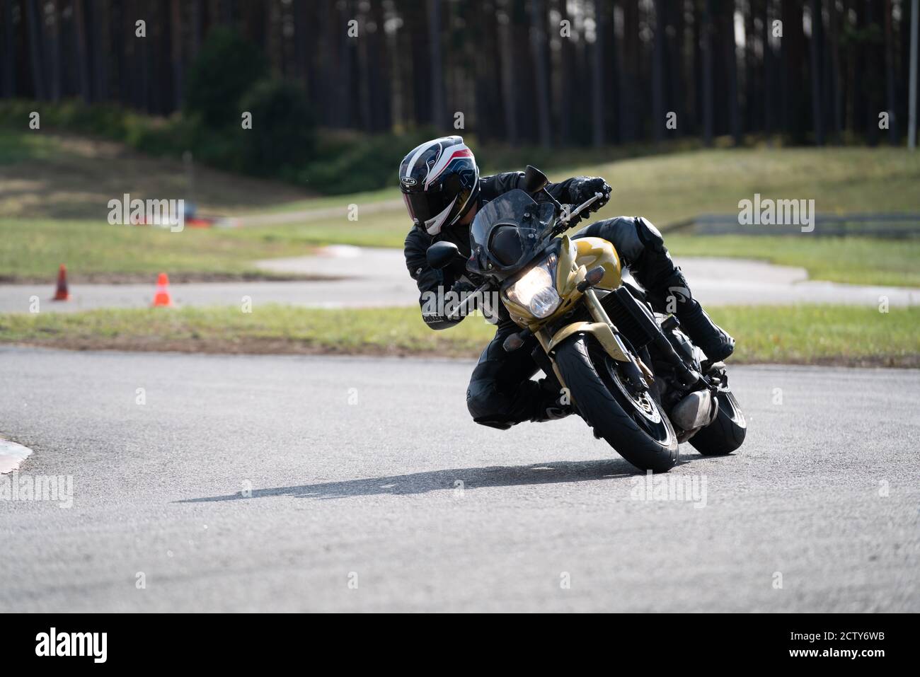 Motorcycle practice leaning into a fast corner on track Stock Photo - Alamy