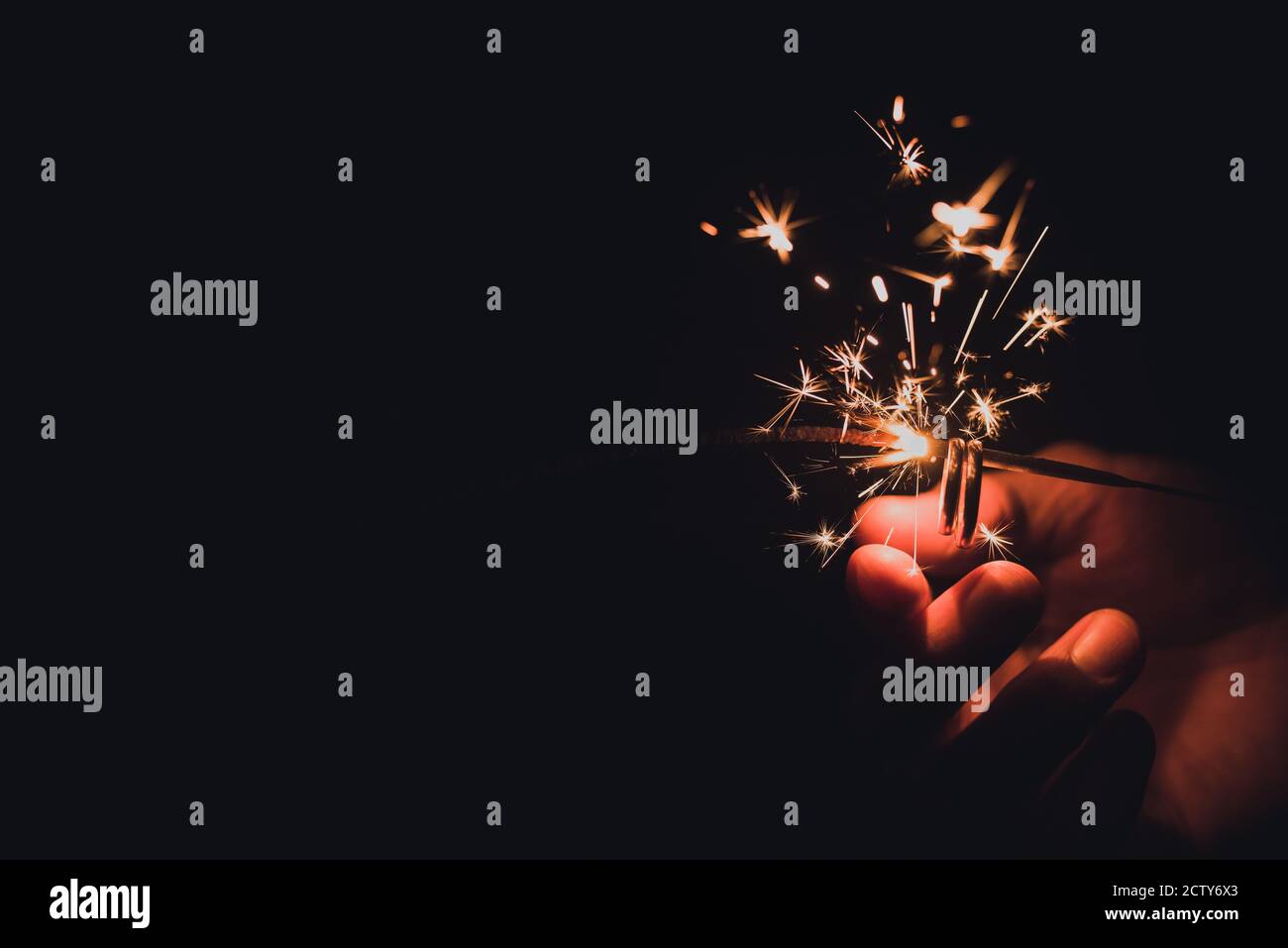 rings on burning sparklers of bride and groom on the background Stock ...