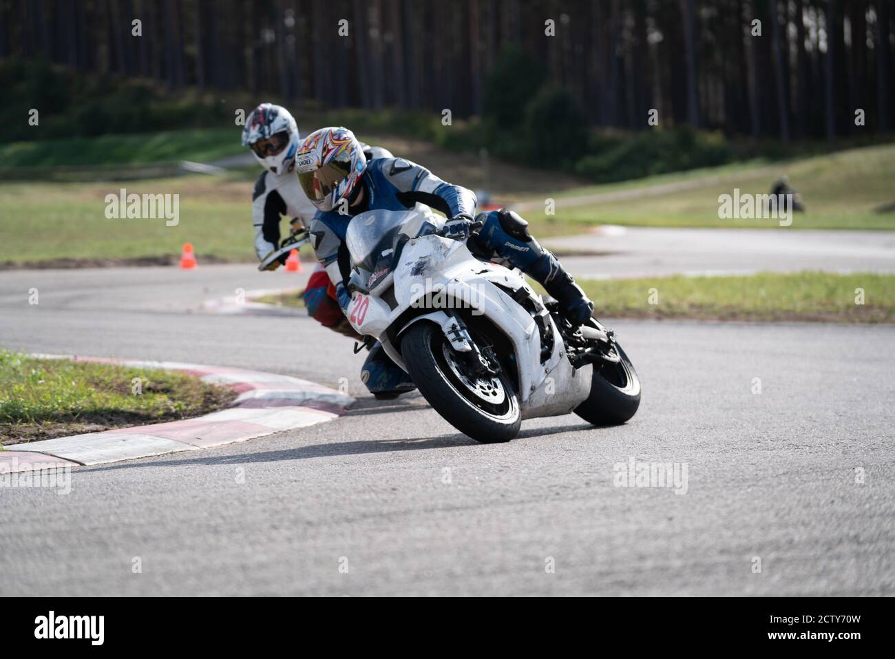 Motorcycle practice leaning into a fast corner on track Stock Photo - Alamy