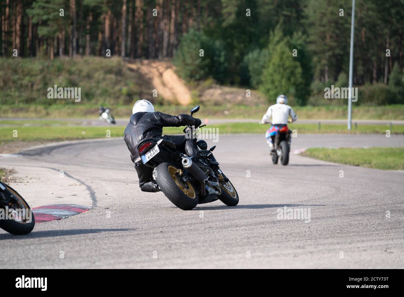 Motorcycle practice leaning into a fast corner on track Stock Photo - Alamy