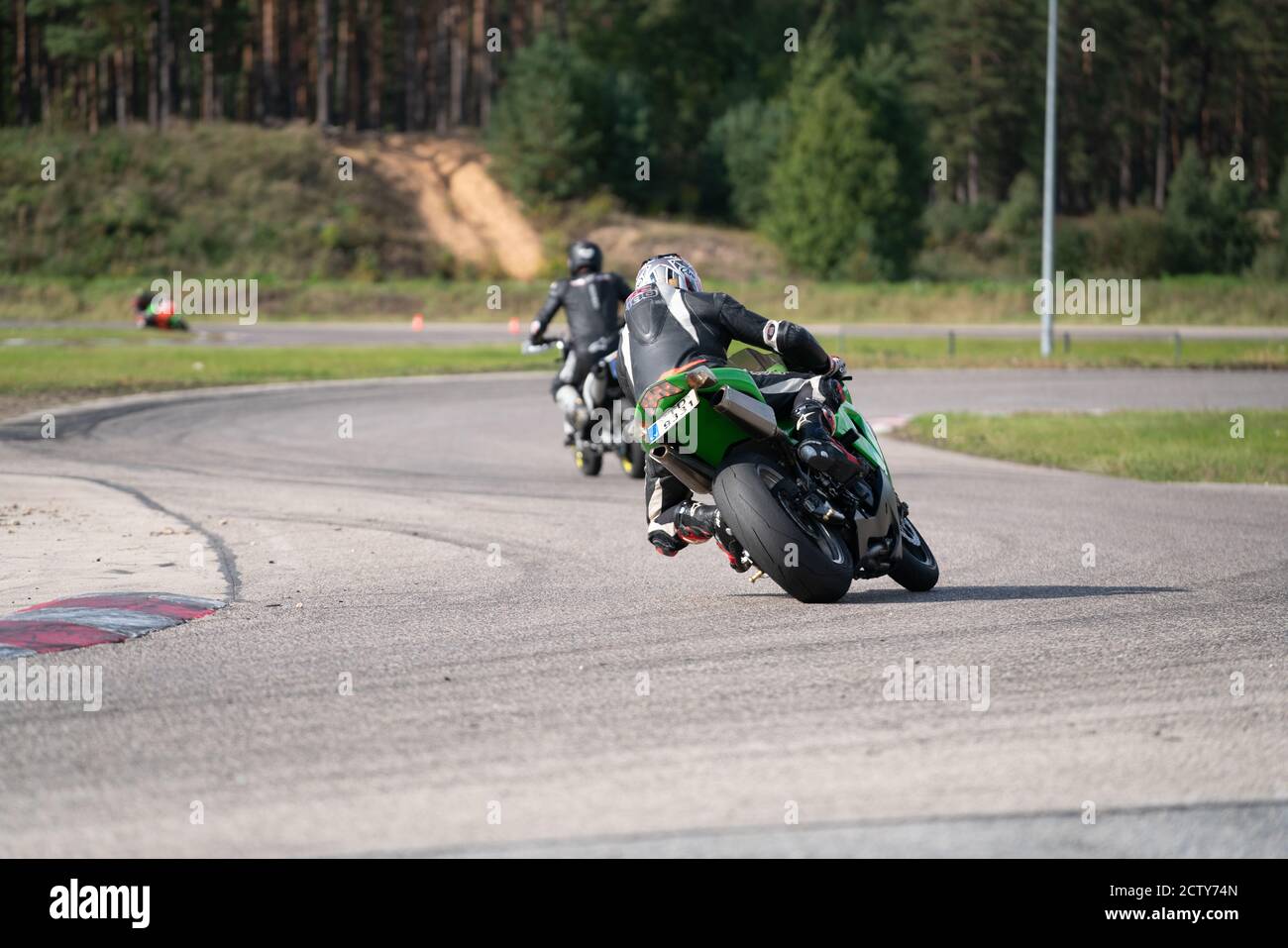 Motorcycle practice leaning into a fast corner on track Stock Photo - Alamy