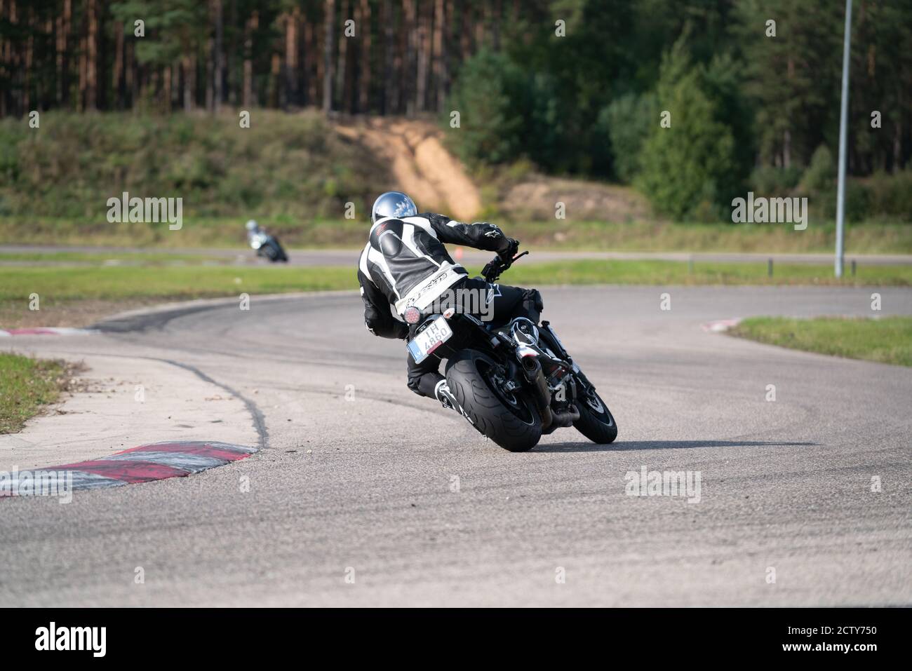 Motorcycle practice leaning into a fast corner on track Stock Photo - Alamy