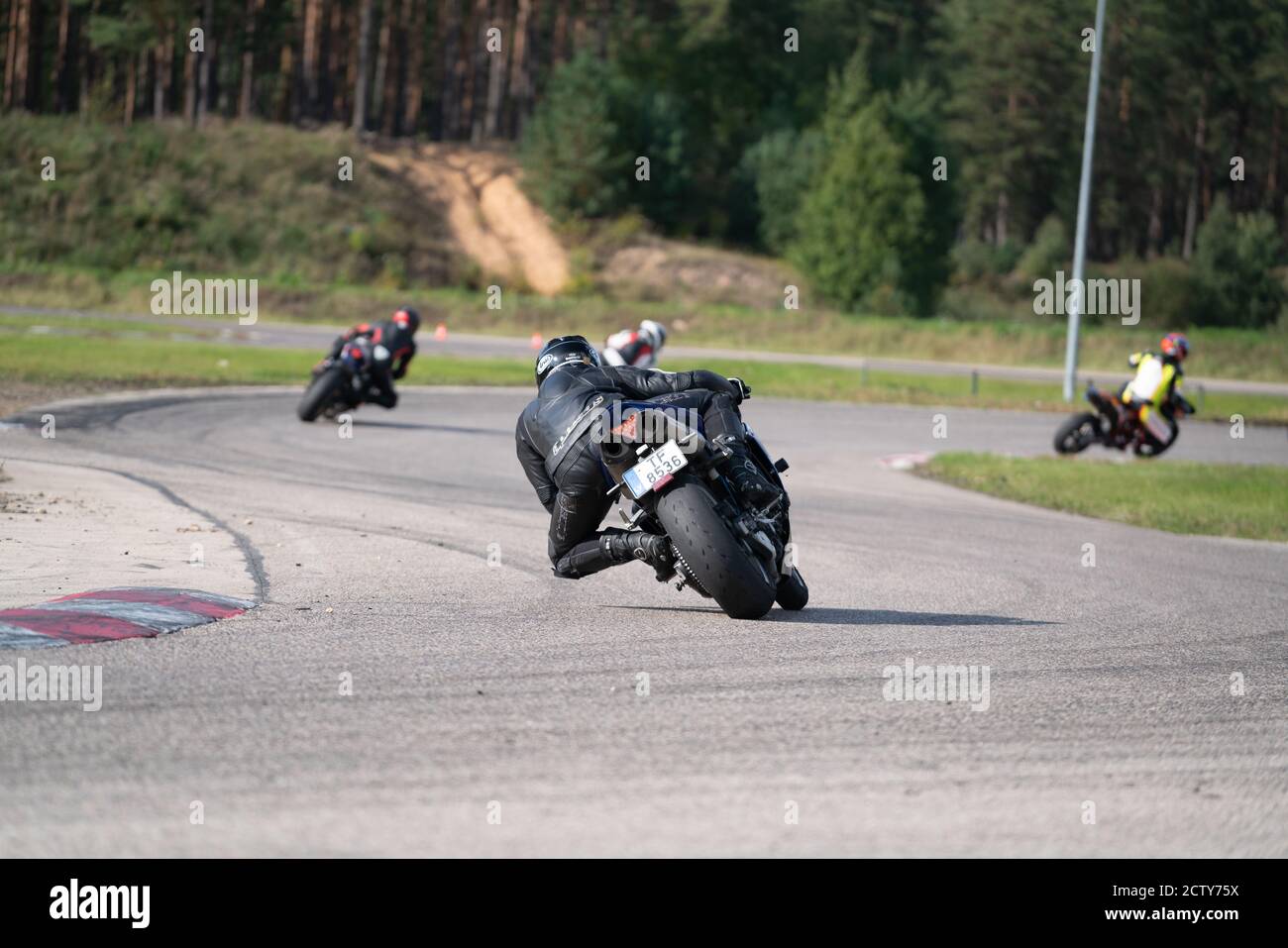 Motorcycle practice leaning into a fast corner on track Stock Photo - Alamy