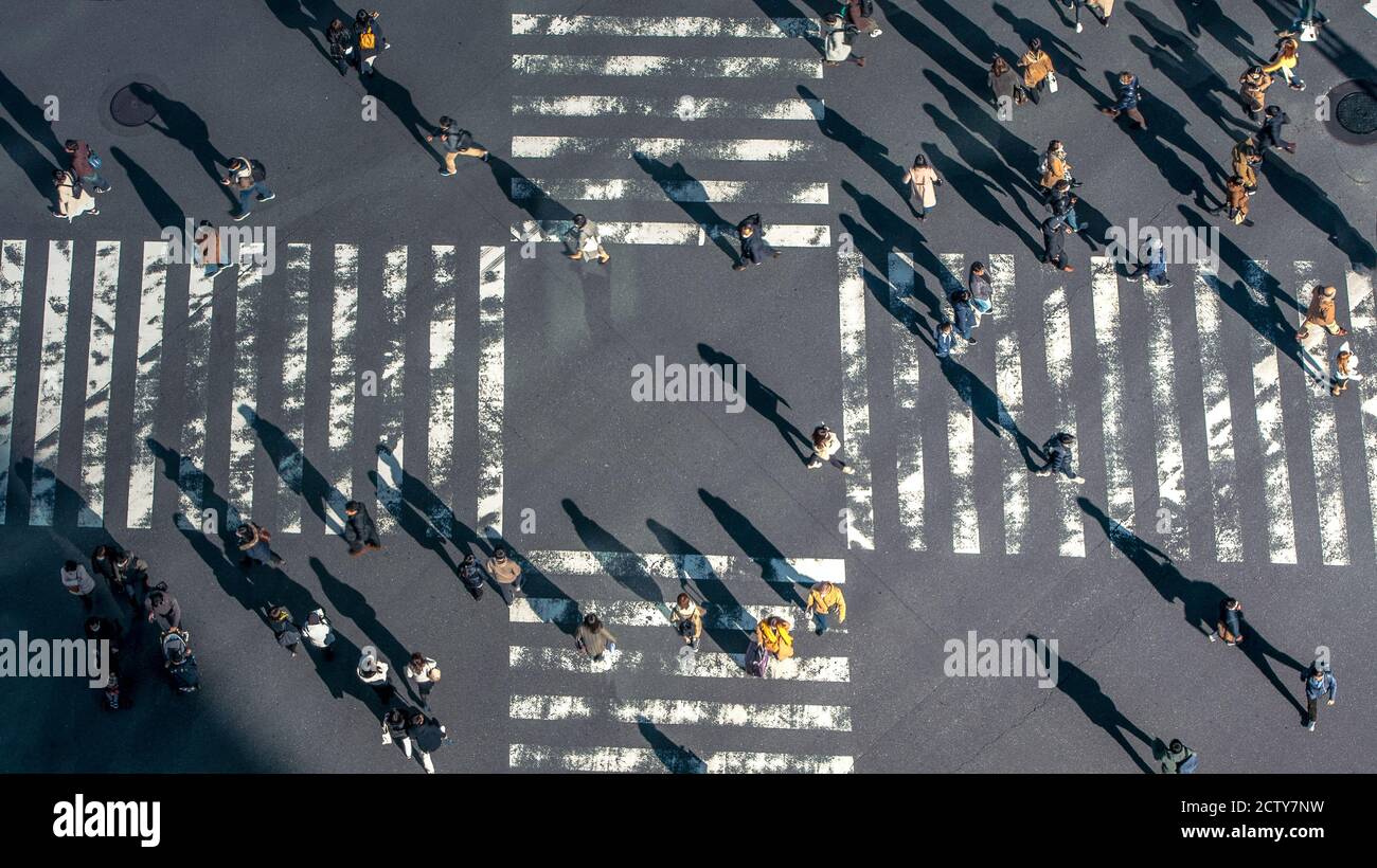 Elevated view over a people on pedestrian crossing in road intersection ...