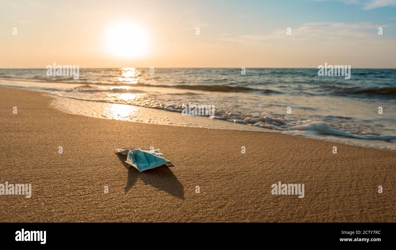 Coronavirus waste polluting the environment at beach. Disposable masks ...