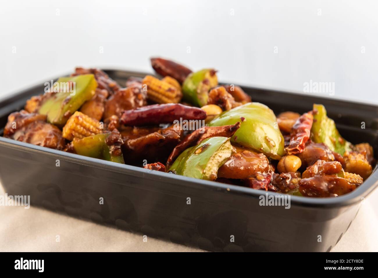 Large bowl of Kung Pao chicken shows the sheen of spicy sauce and meat ...