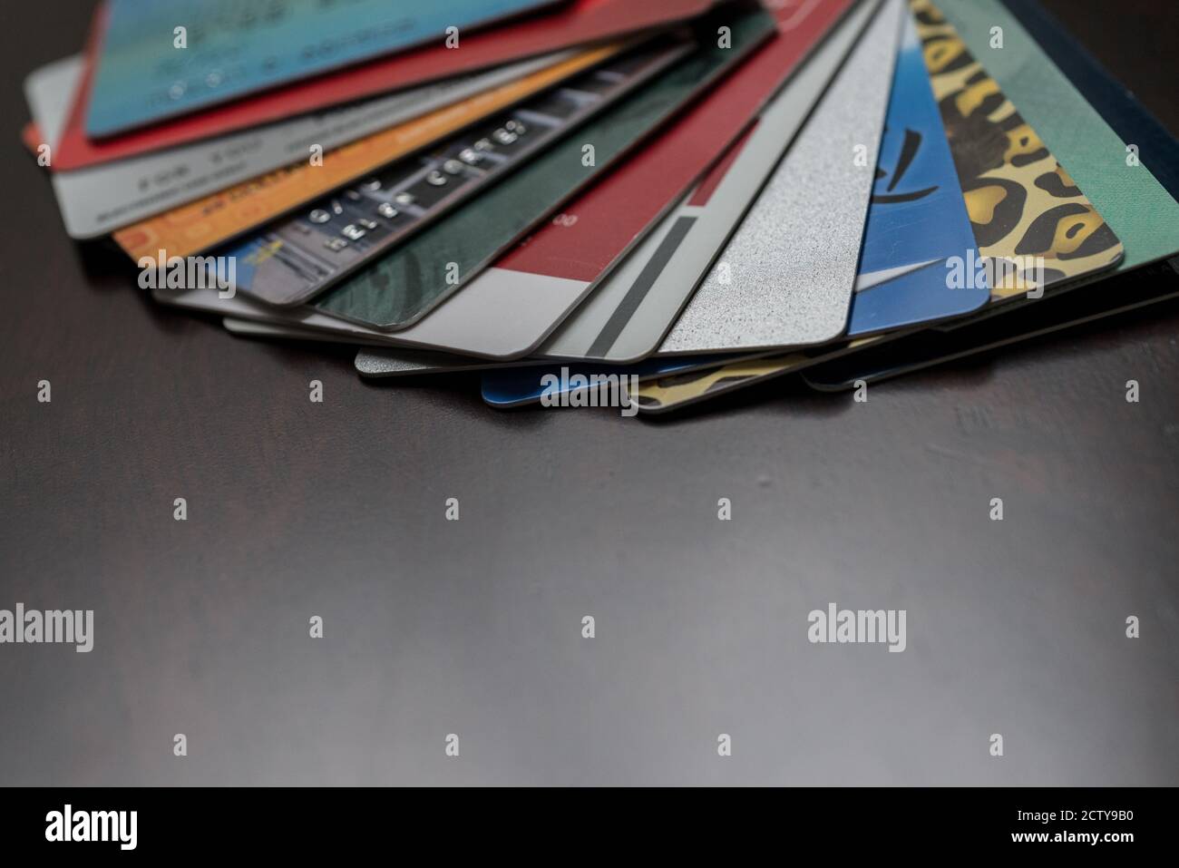 Different credit cards stack on top of wooden dark brown table Stock ...