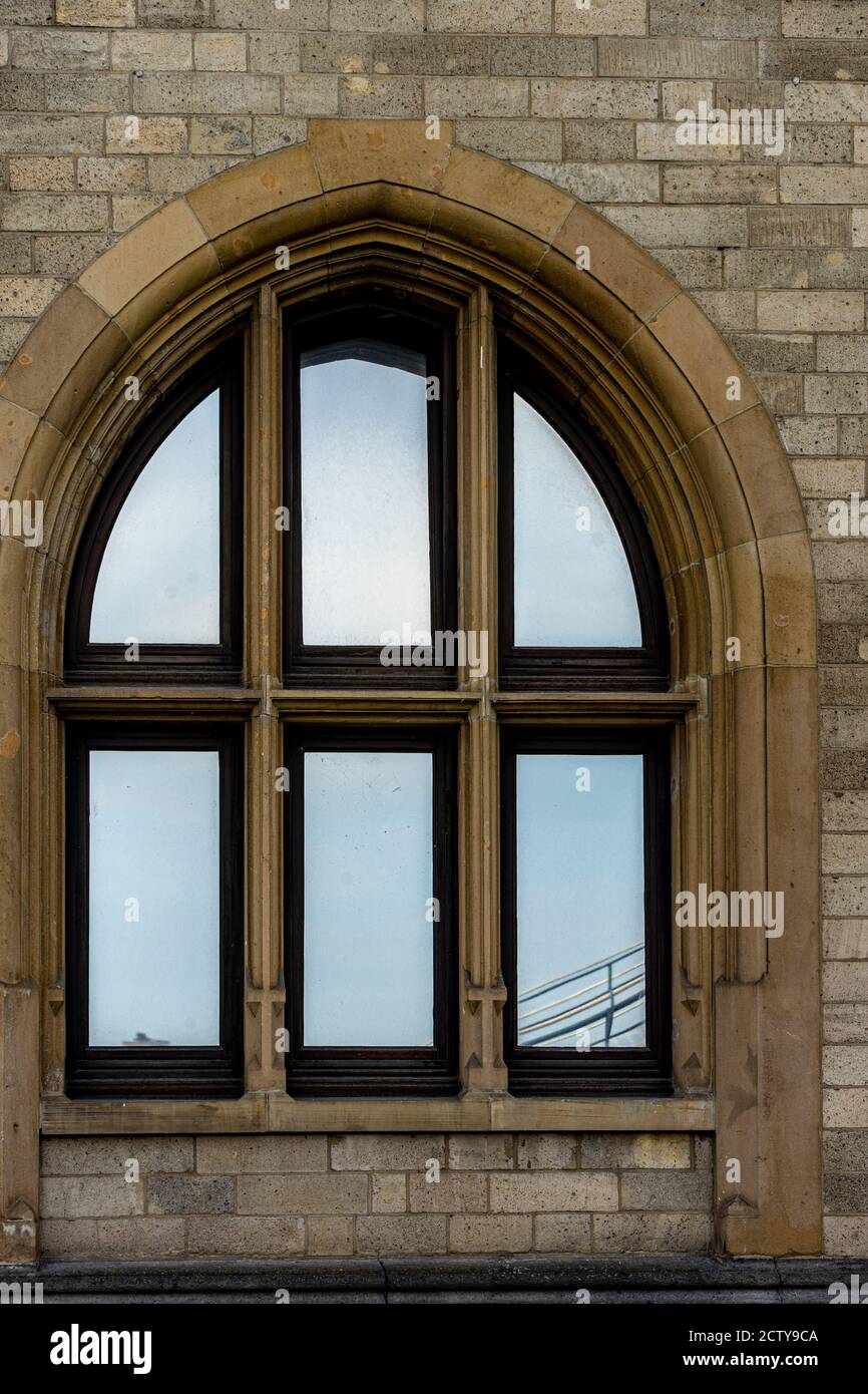 Vertical shot of an arch-shaped window of a stone building Stock Photo ...