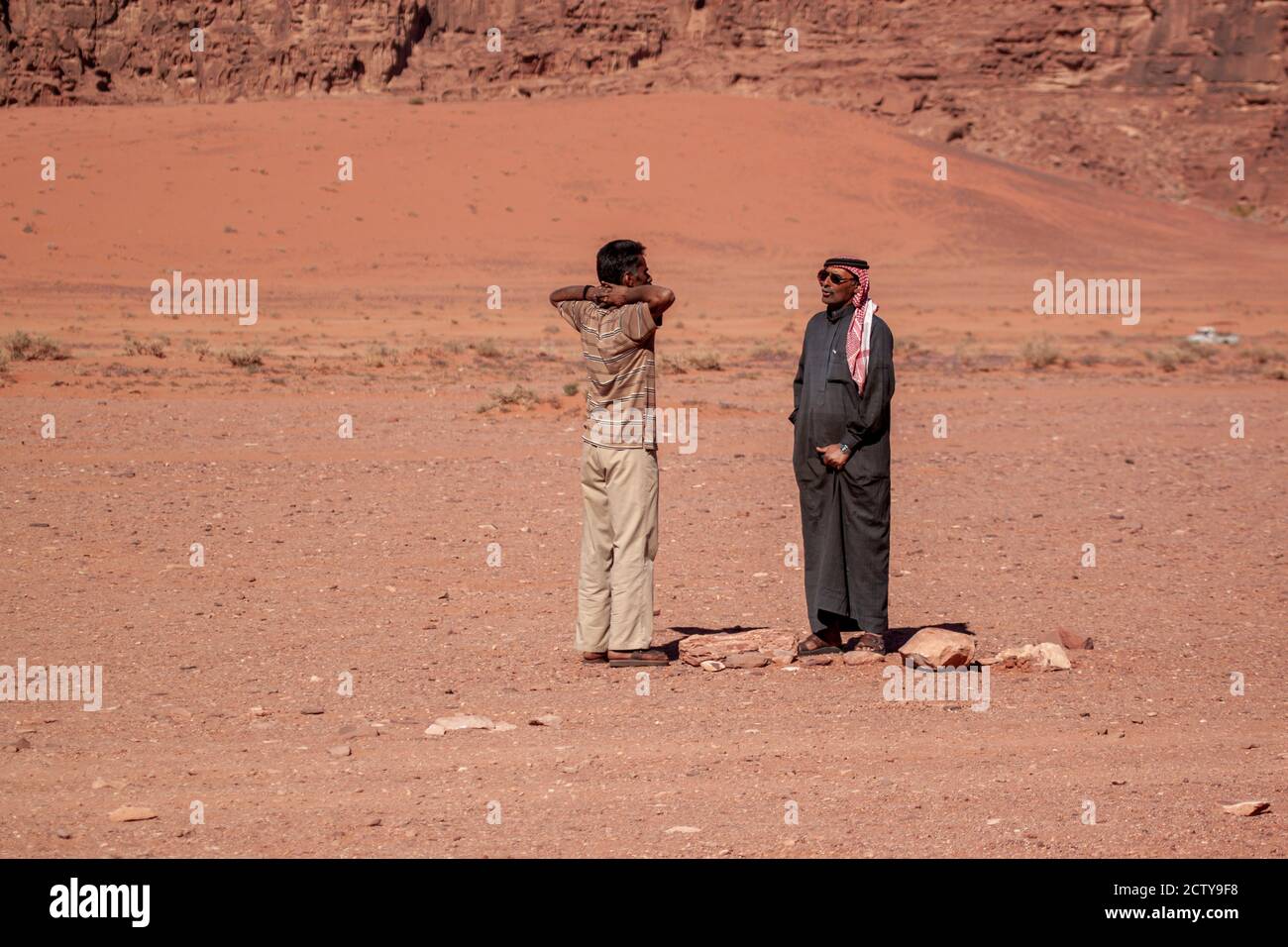 Wadi Rum, Jordan 04/01/2010: Two men are seen having a conversation in ...