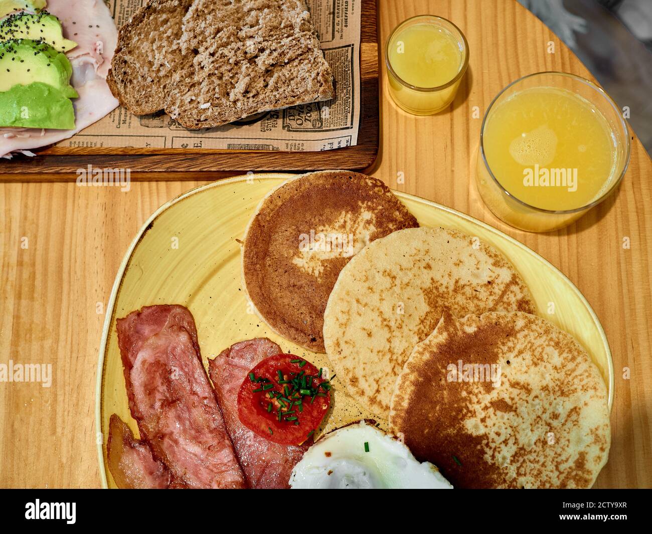 Top of view of American breakfast with eggs, bacon, toast, pancakes ...