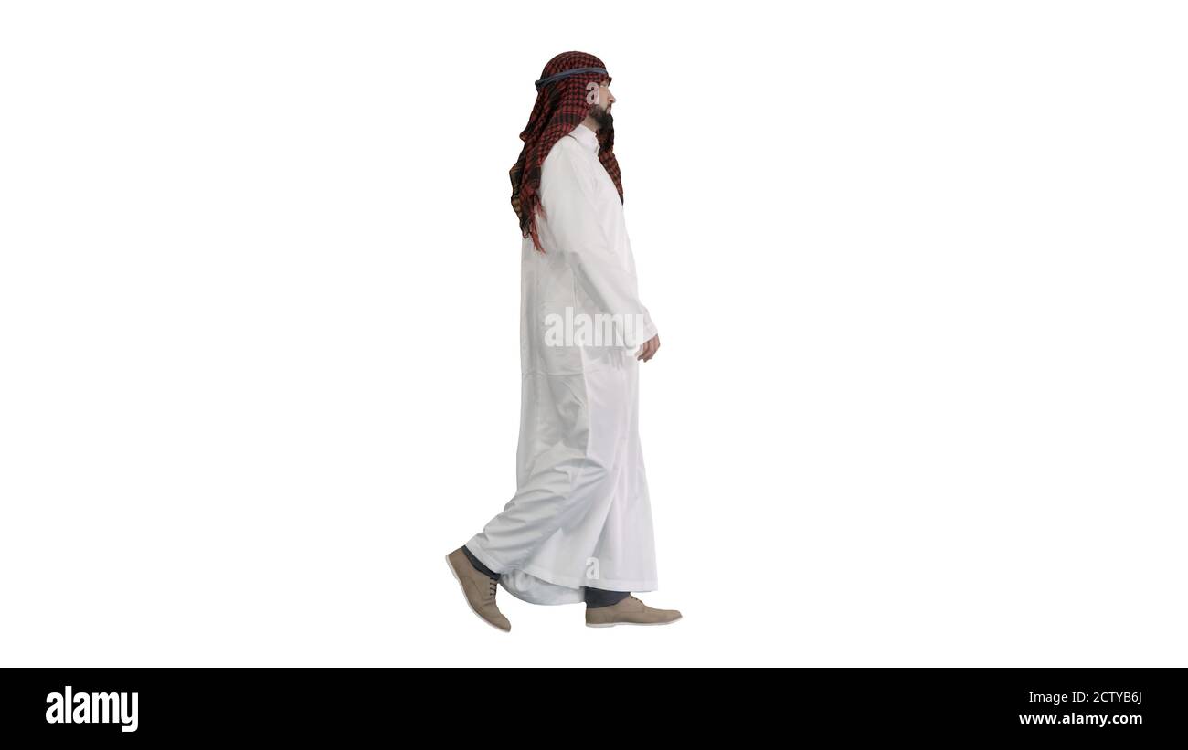 Serious sheikh having a walk on white background Stock Photo - Alamy