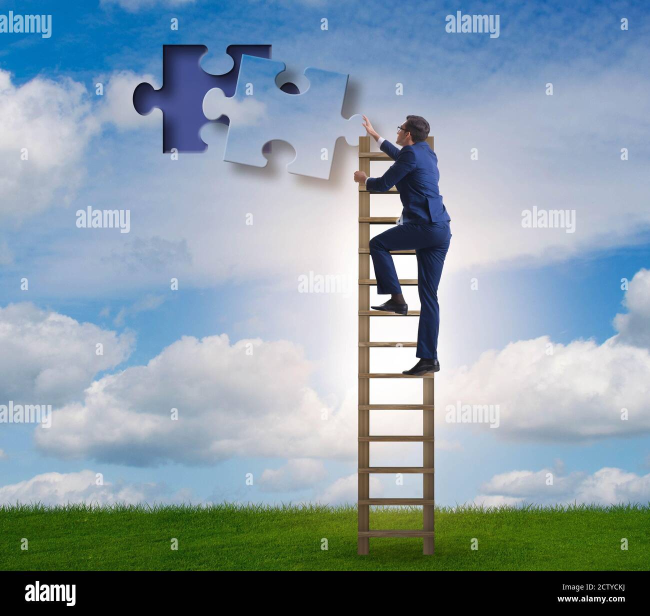 The businessman putting together jigsaw puzzle pieces Stock Photo - Alamy