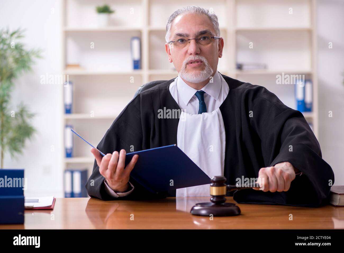Old judge working in courthouse Stock Photo - Alamy