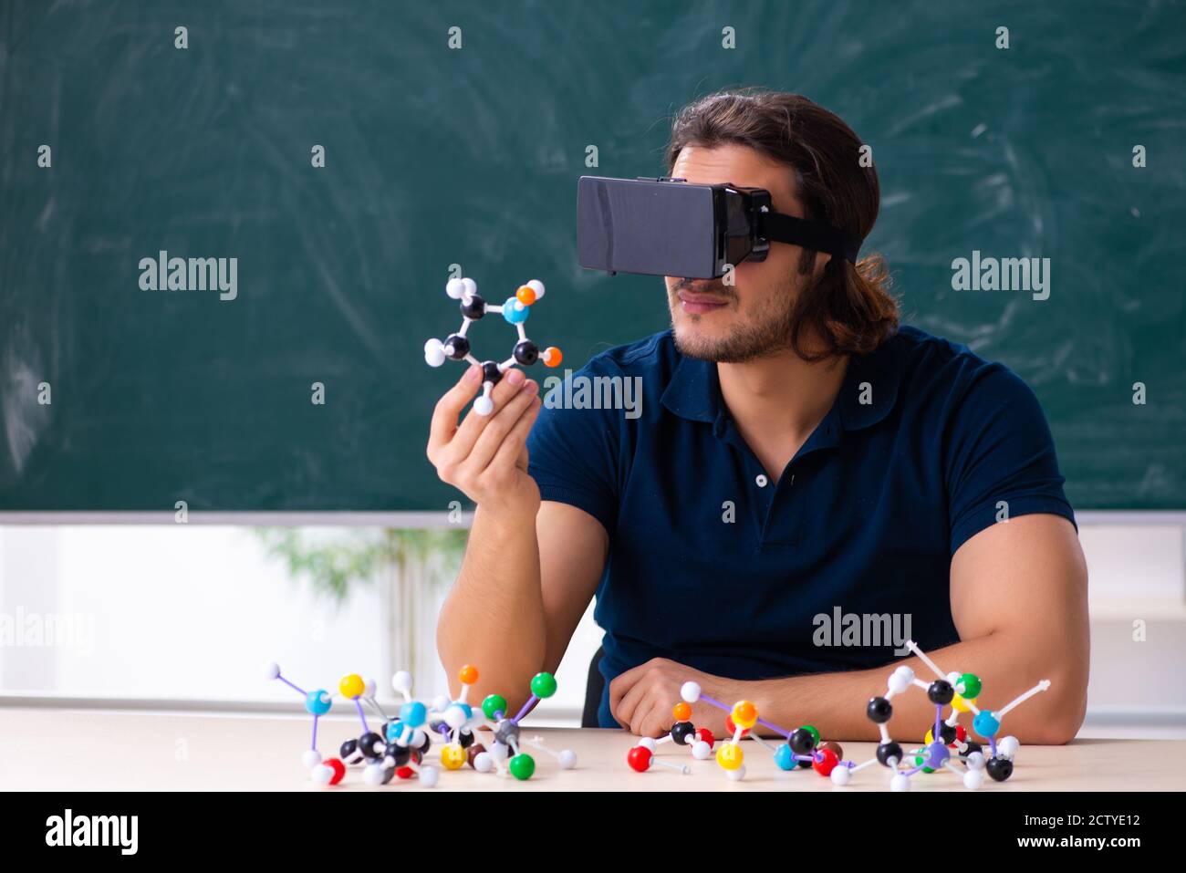 Young scientist sitting in the classroom Stock Photo - Alamy