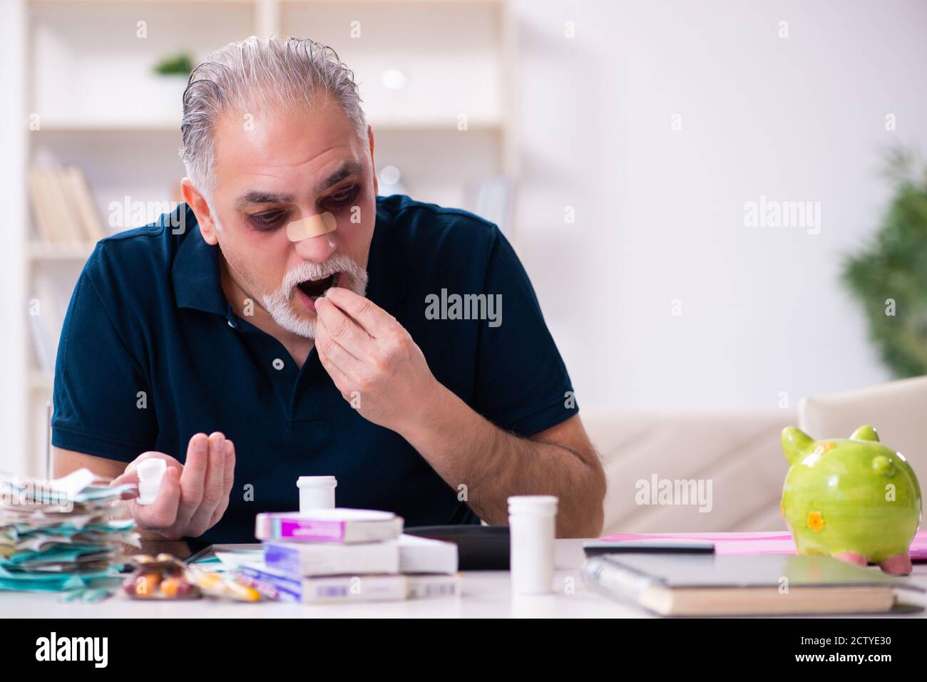 Old man in budget planning concept Stock Photo - Alamy