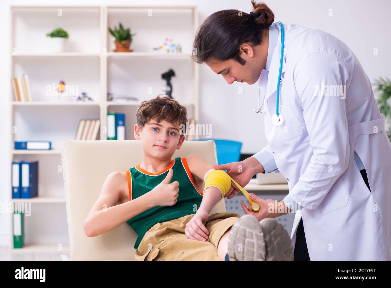 Sick boy visiting young doctor pediatrician Stock Photo - Alamy