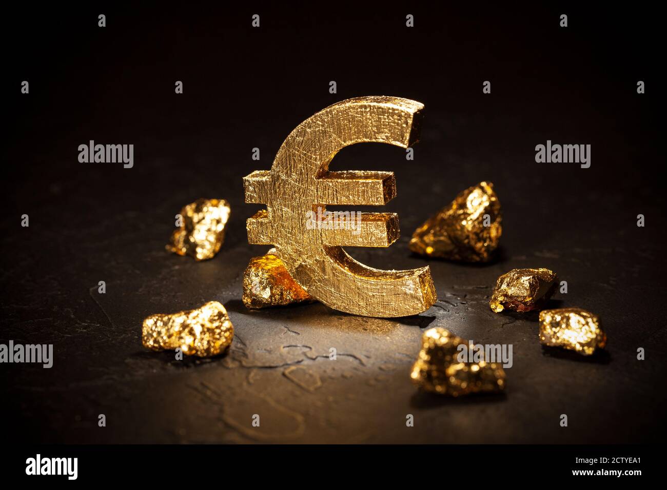 Gold euro sign and gold nuggets on black background Stock Photo - Alamy