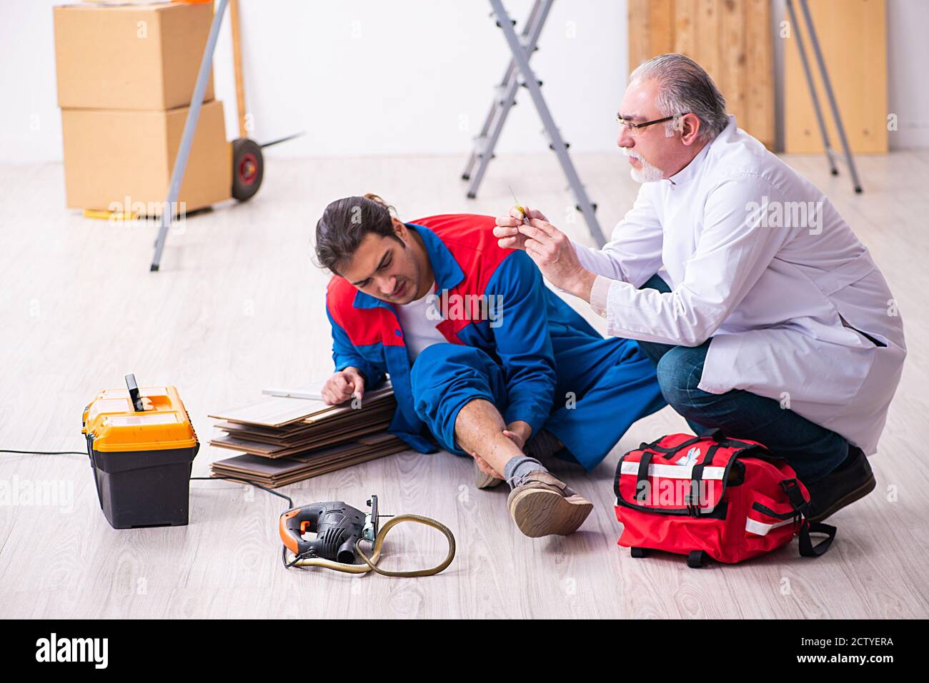 Experienced paramedic helping worker bitten by snake Stock Photo - Alamy