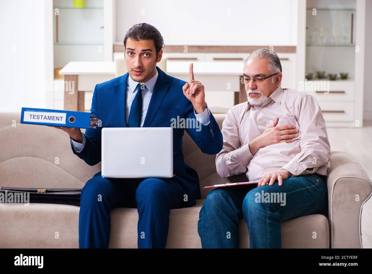 Young lawyer visiting old man in testament concept Stock Photo - Alamy