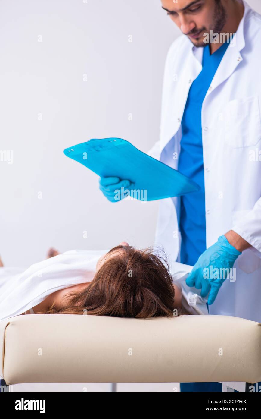 Police coroner examining dead body in morgue Stock Photo - Alamy
