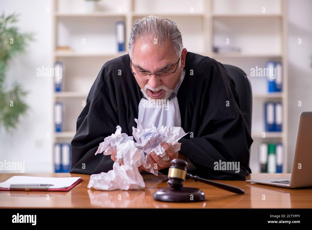 Old male judge working in the courthouse Stock Photo - Alamy