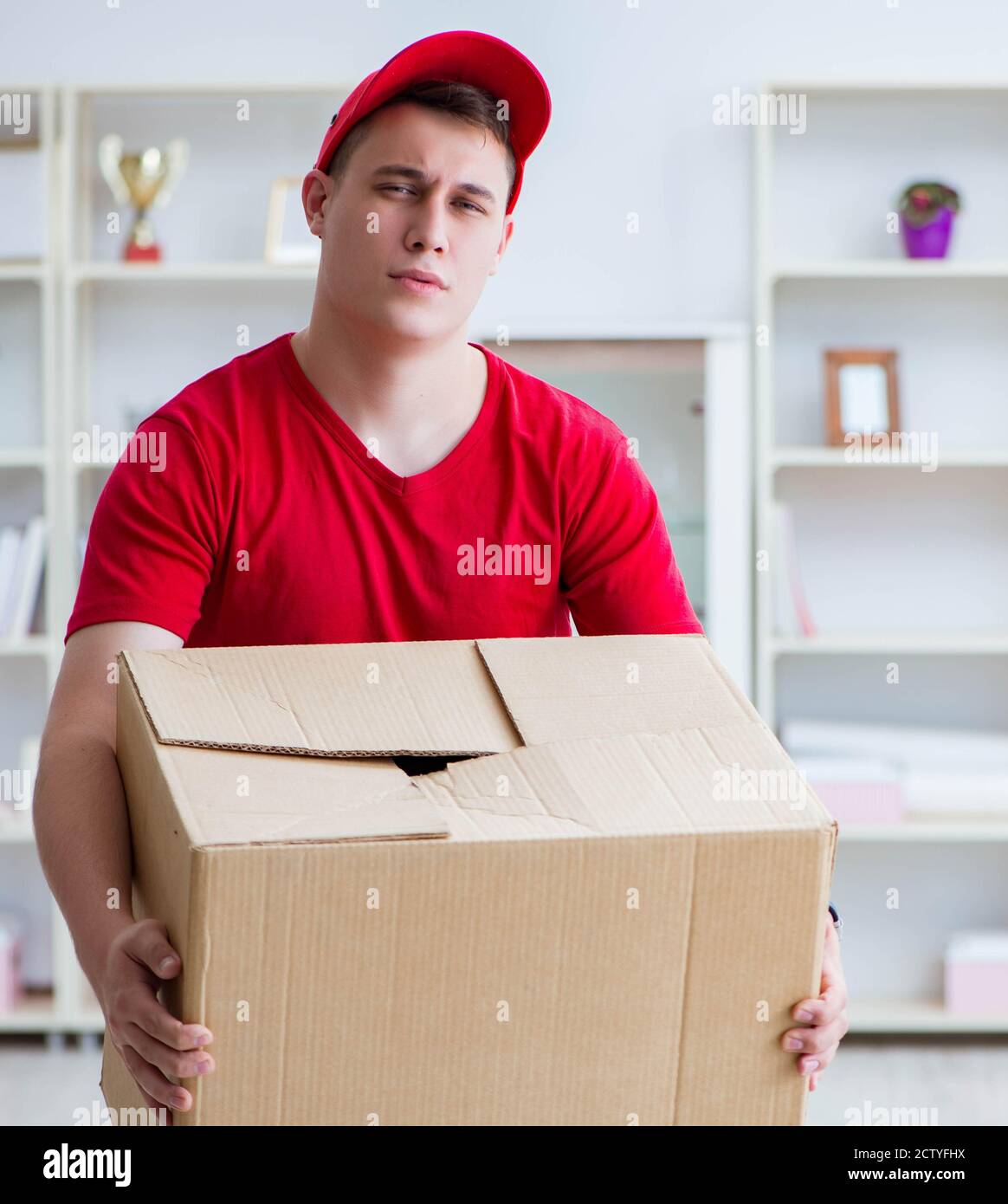 Post man delivering a parcel package Stock Photo - Alamy