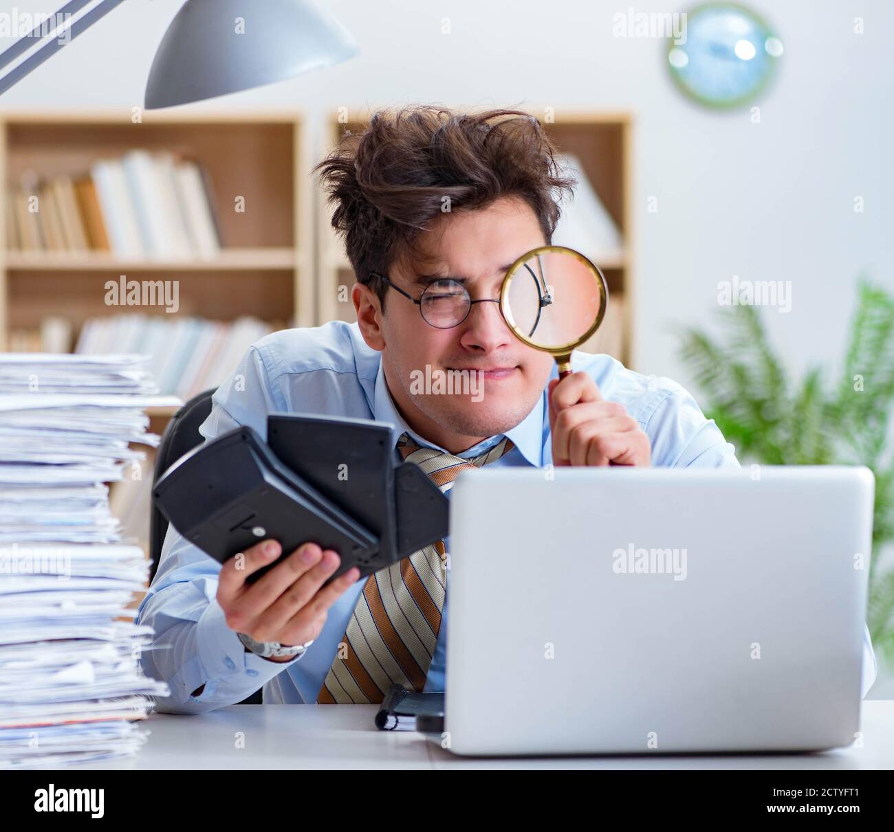 The mad auditor looking for errors in the report Stock Photo - Alamy