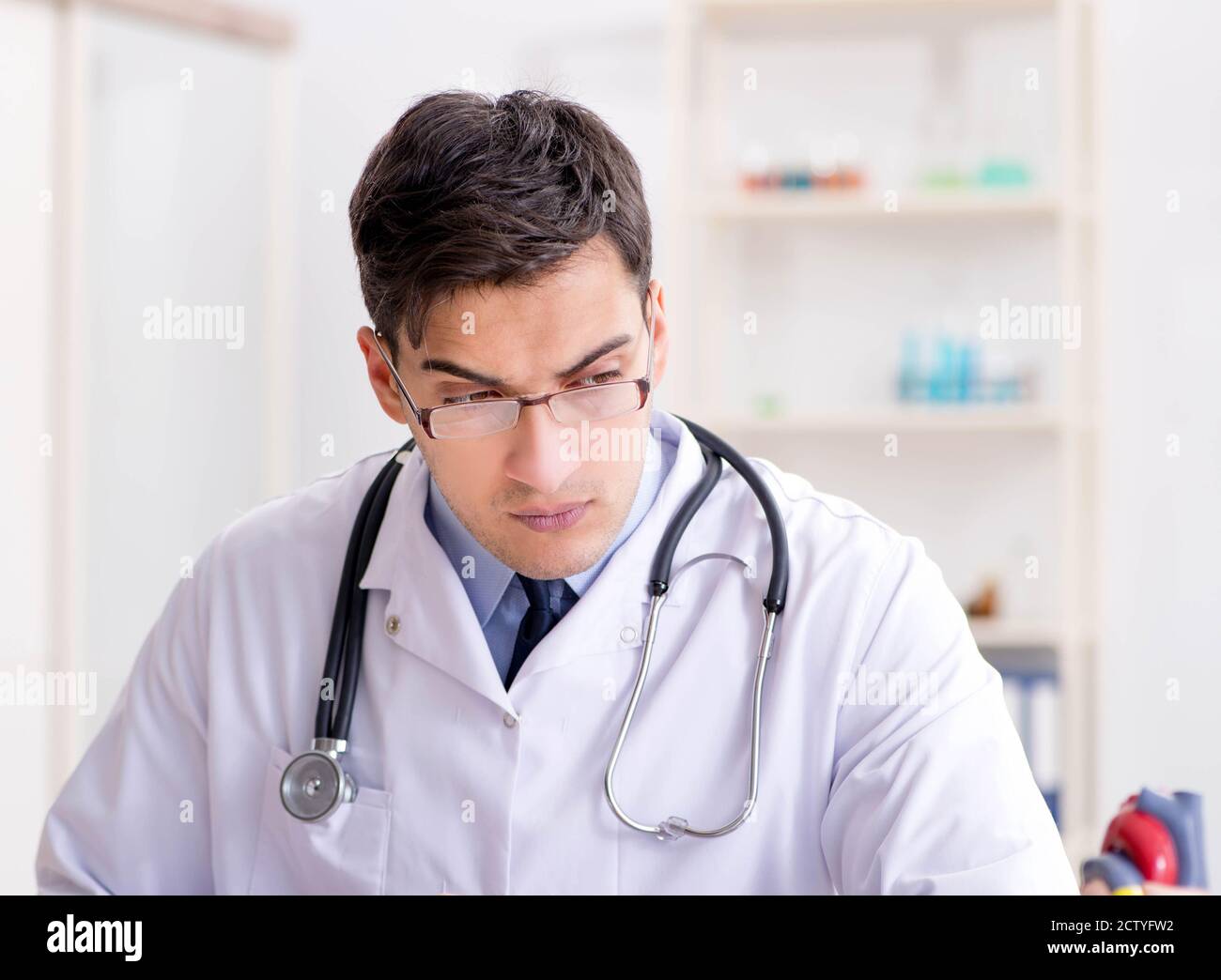 The doctor lecturer explaining the heart model Stock Photo - Alamy